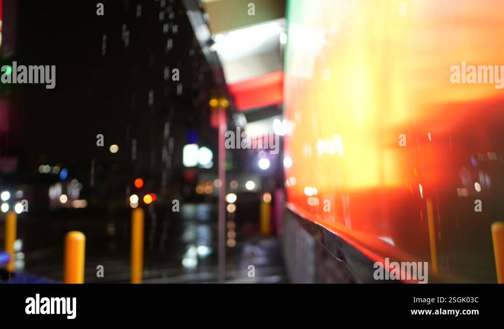 Rain drops drip from roof. Rainwater trickle at night. Rainfall on city ...