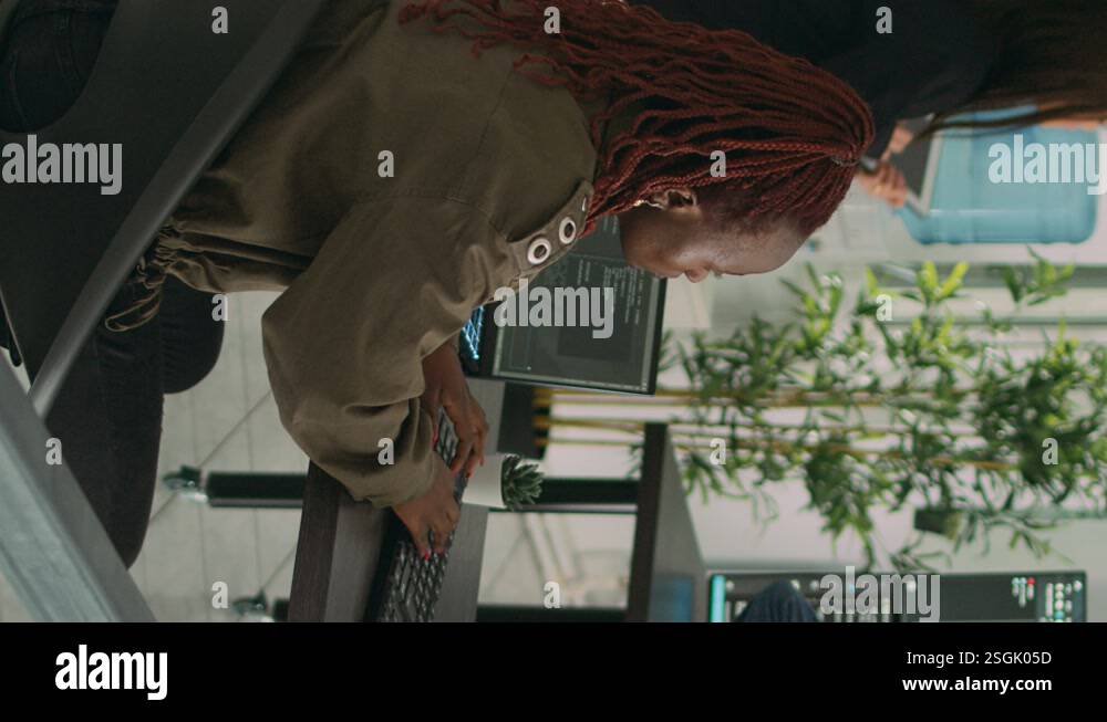 Vertical video: African american programer typing source code on ...