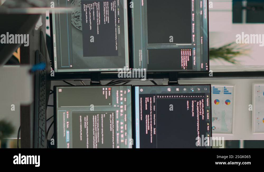 Vertical video: Empty office desk with multiple screens running ...