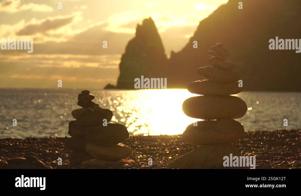 Balanced rock pyramid on pebbles beach, sunny day and clear sky at ...