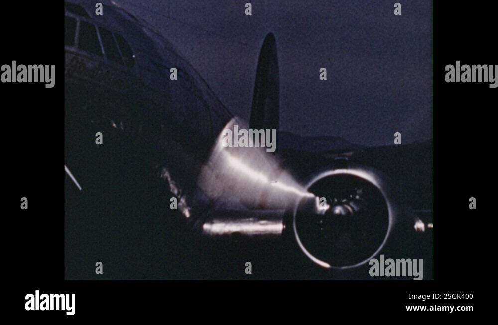 1940s: Man & woman at the steps of a TWA jet, the man checks his ...