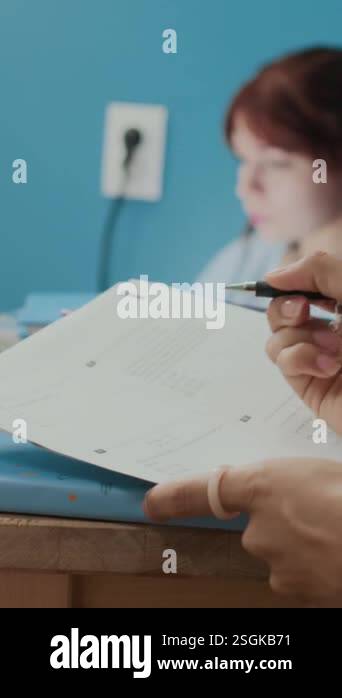 Vertical close-up view of unrecognisable college girl doing math ...