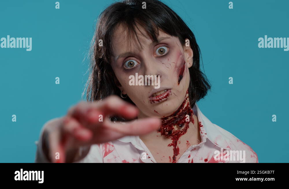 Undead zombie woman with bloody and deep wounds on neck prowling at ...