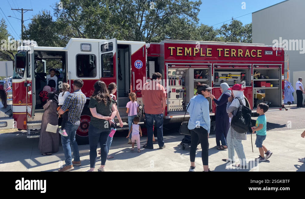 A crowd of people around a firefighter rescue truck at a fire and ...