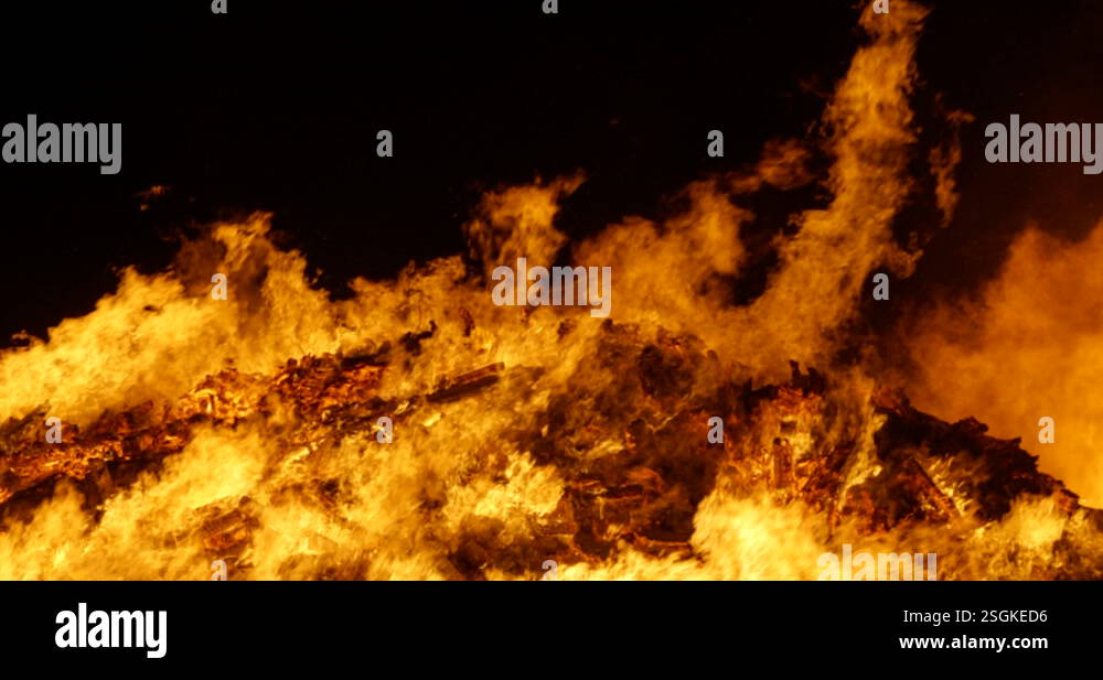 The top of a huge bonfire burns furiously, close up, on Guy Fawkes ...