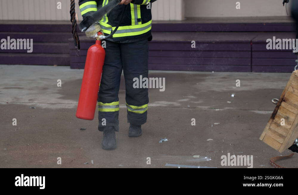 Unrecognizable Firefighter Practice using fire-extinguisher to ...
