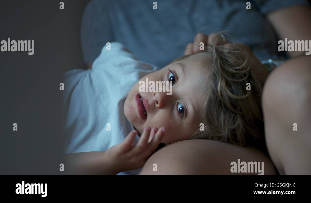 Relaxed Child laid on mother leg closeup kid face. Mom caressing young boy ha Stock Video ...