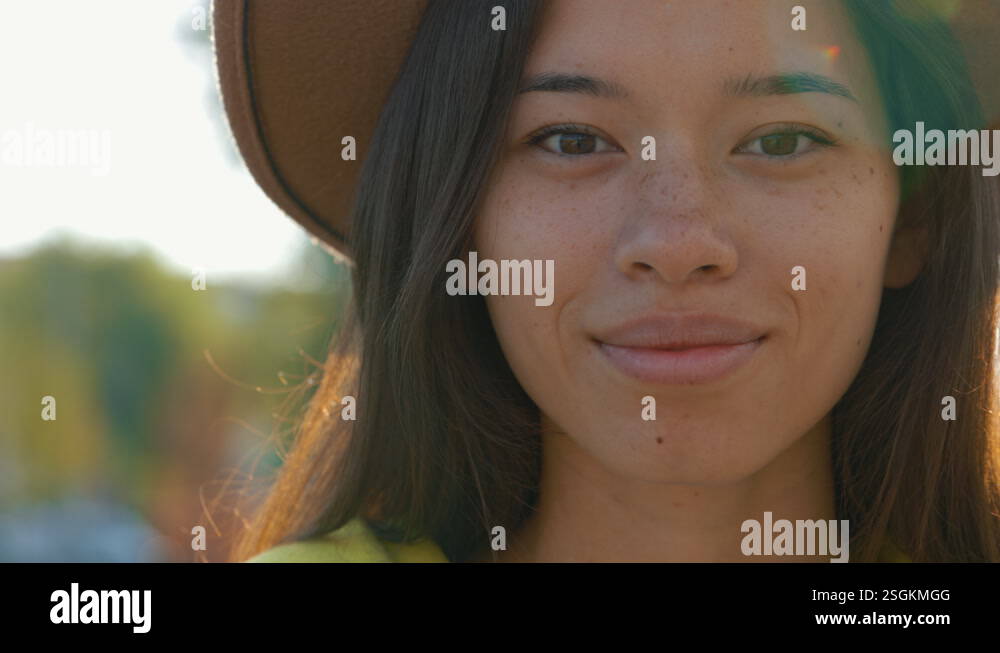 Portrait of the smiled asian woman , wearing hat standing near the ...