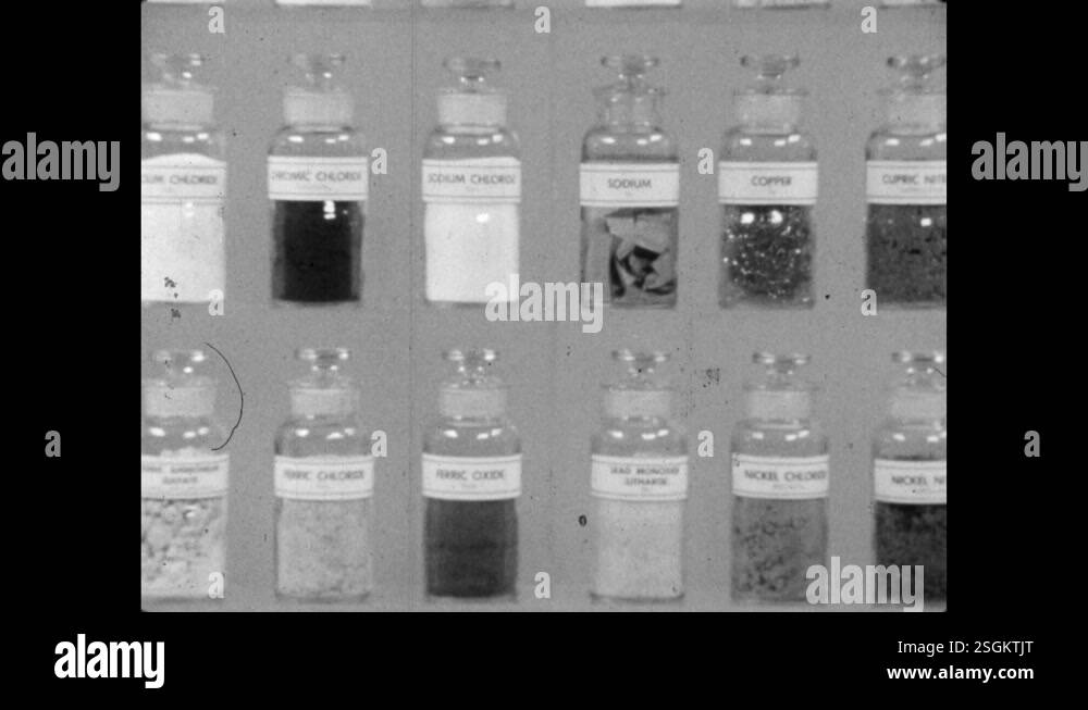1960s: Labeled glass lab bottles of various chemicals. Helium gas tank ...