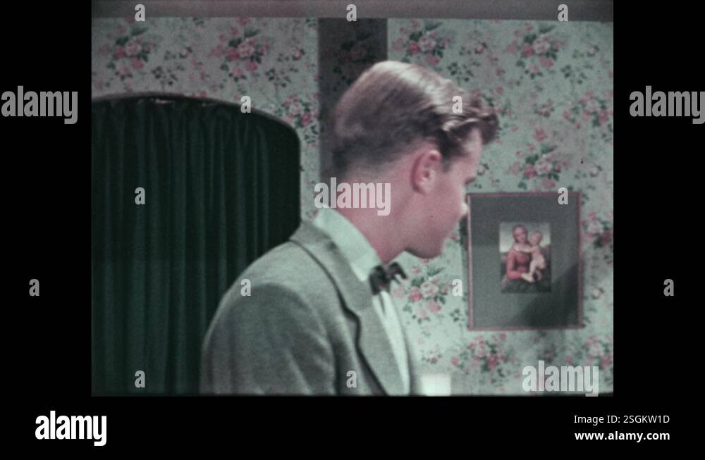 1950s: Medium shot of teen boy in bow tie waiting for his date, pacing ...