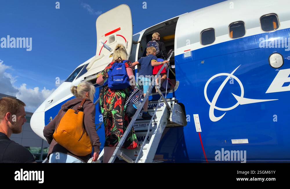 People boarding and walking up the stairs on a big Ryanair boeing ...