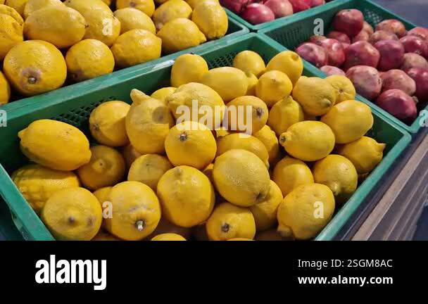 Sale of lemons in a supermarket. Citrus fruits in plastic boxes, close ...
