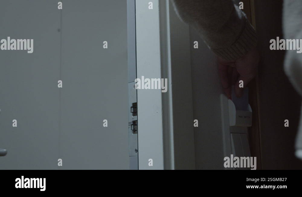 Close Interior detail shot, young man enters hotel room and inserts ...