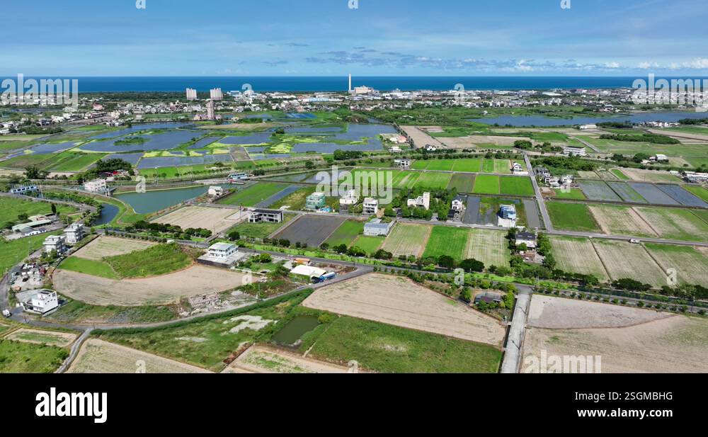 Drone fly over the Yilan County with lots of rice field and meadow ...
