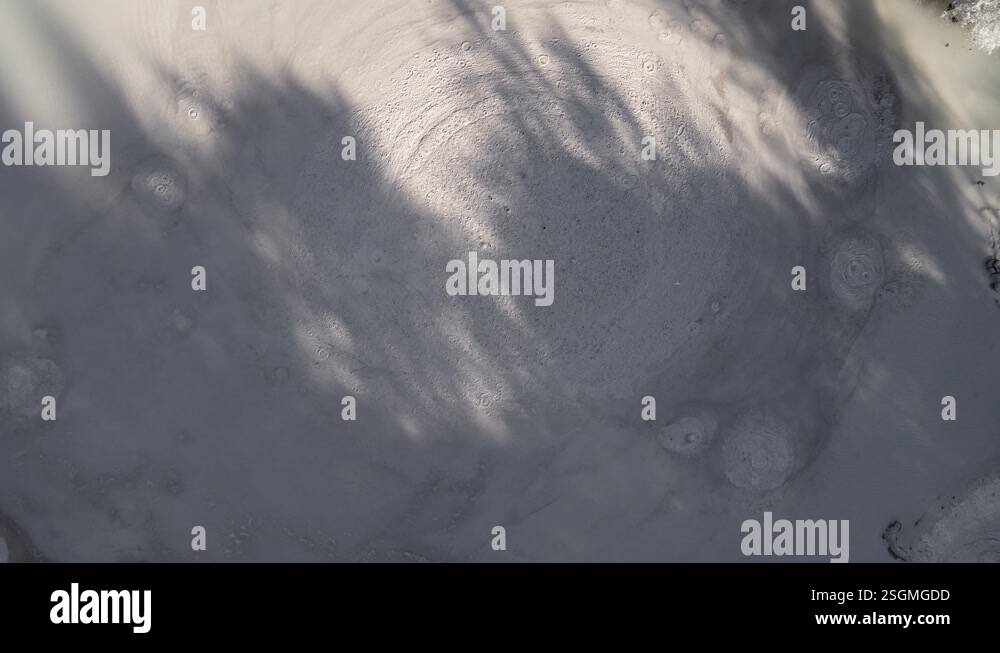 Top-down drone view of hot bubbling mud with soft shadows of the Stock ...