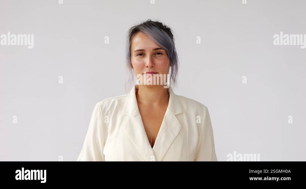 Young woman stares intently, eye from head to foot and look sternly ...