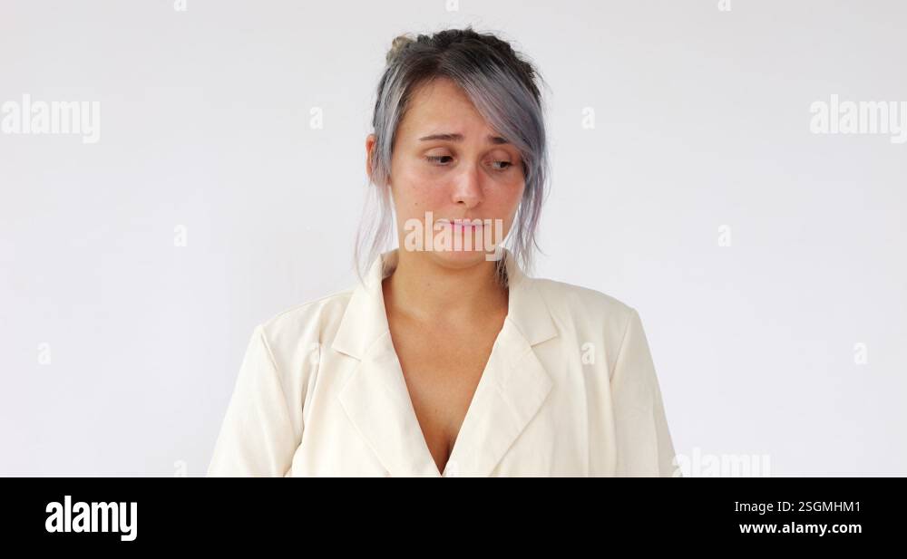 Ashamed and guilty young woman looks aside, listens to accusations and ...