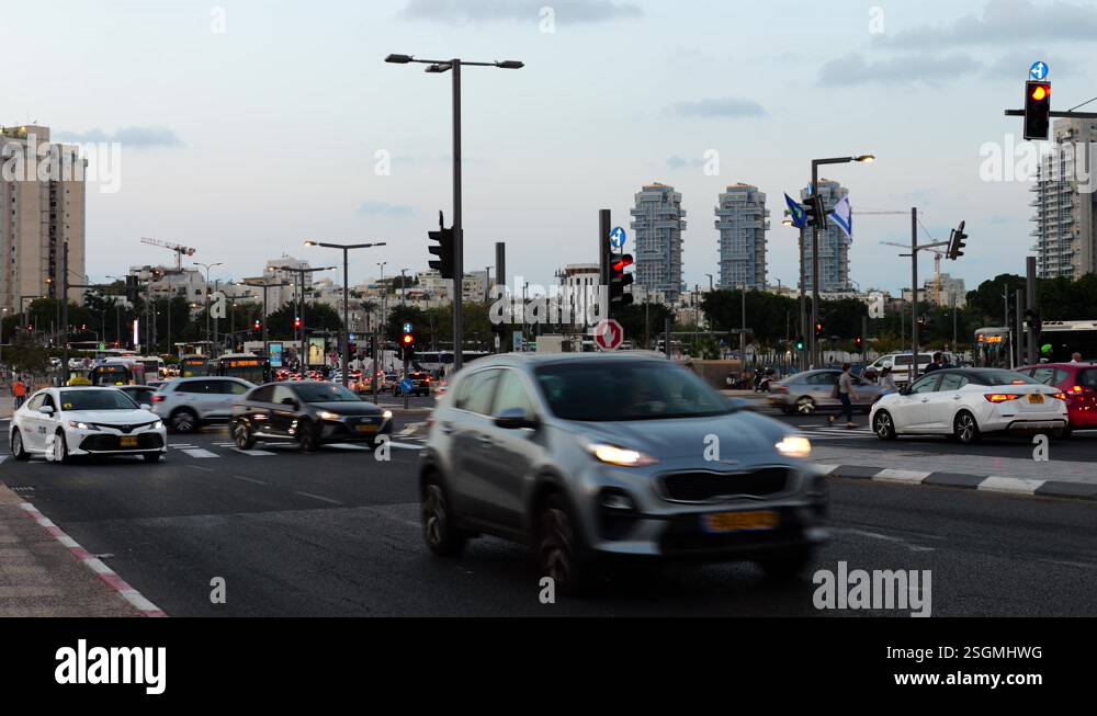 Pedestrians crossing a busy street at traffic light, Tel Aviv, Israel ...