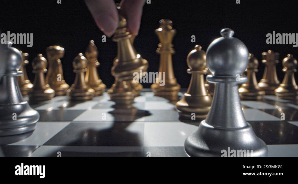 Shot pushing in through a chess set while a hand moves the enemy's ...