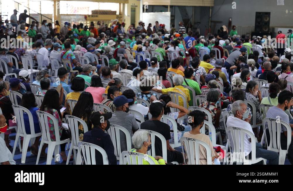 people in different areas wait in groups or a crowd sitting calmly ...