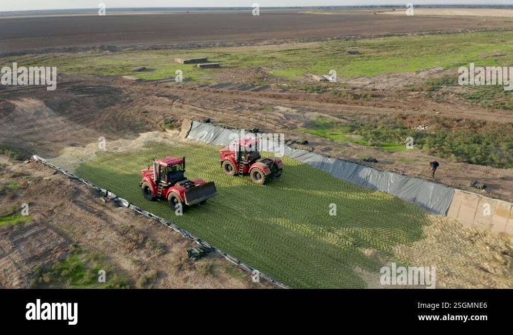 Two Red Tractors Tamp Silage in the Silo Trench Stock Video Footage - Alamy