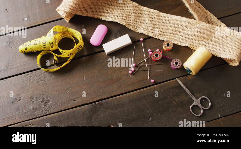 Video of measure, scissors, chalk, pins, threads and hessian on wooden ...