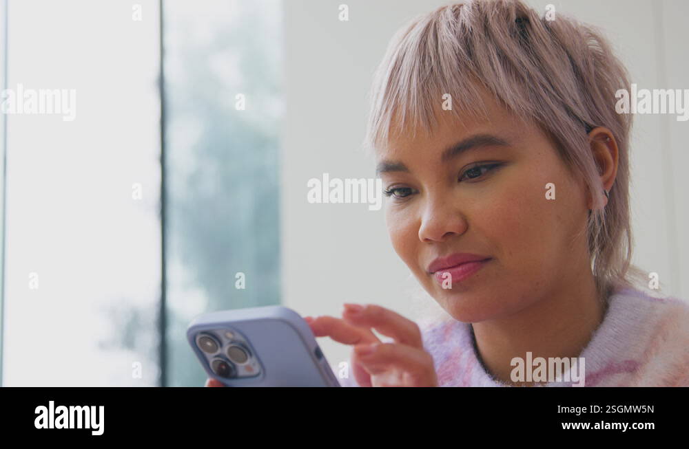 Close Up Of Young Woman At Home Scrolling Through Social Media On Mobile Phone Stock Video ...