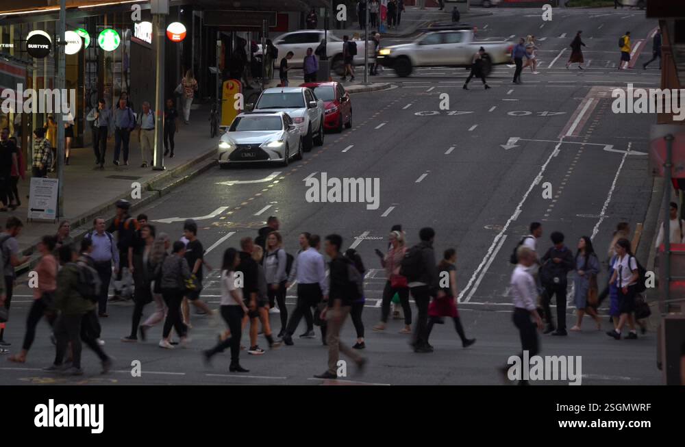 Large crowd of people crossing at the intersection between Adelaide and ...