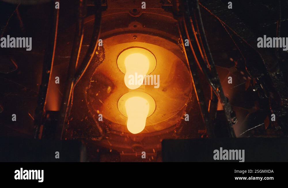 Molten glass pouring out of a Glass melting furnace in a bottle ...
