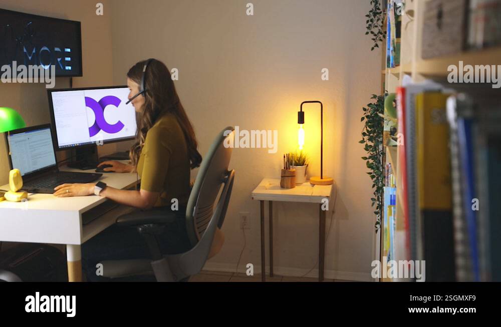 Sliding reveal shot of a female working from home at desk on the ...