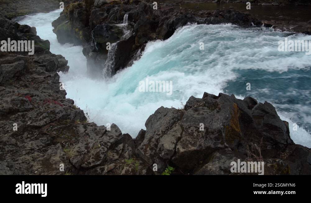 Spectacular blue colored waterfall crashing down edge in slow motion in ...
