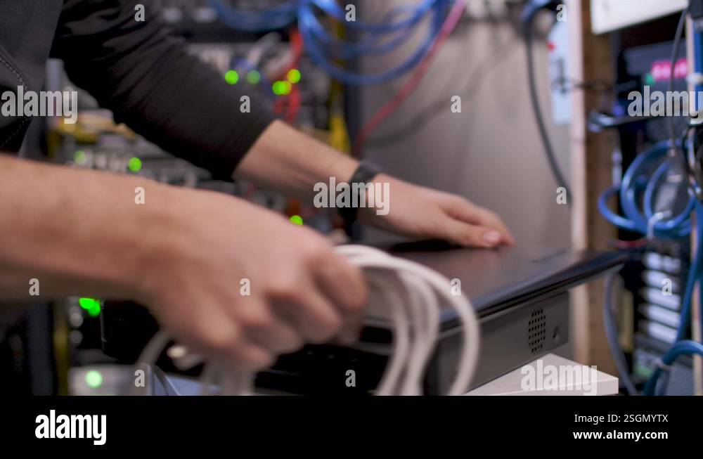 Man Setting Up Laptop And LAN Cable In The Server Room. close up Stock ...