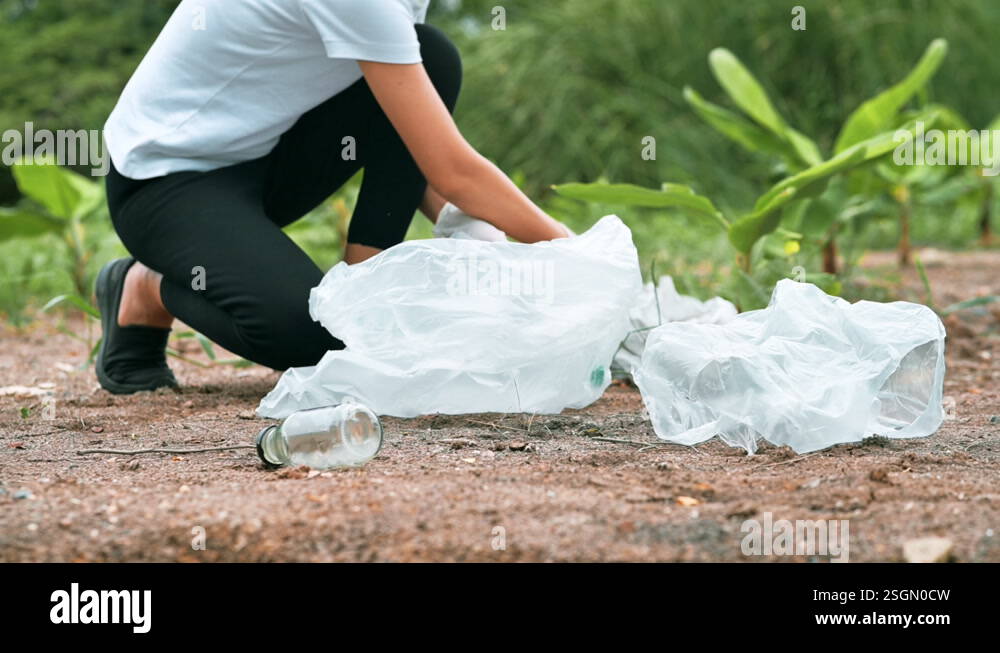 woman is collecting recycling junk on ground , ecological sustainable ...