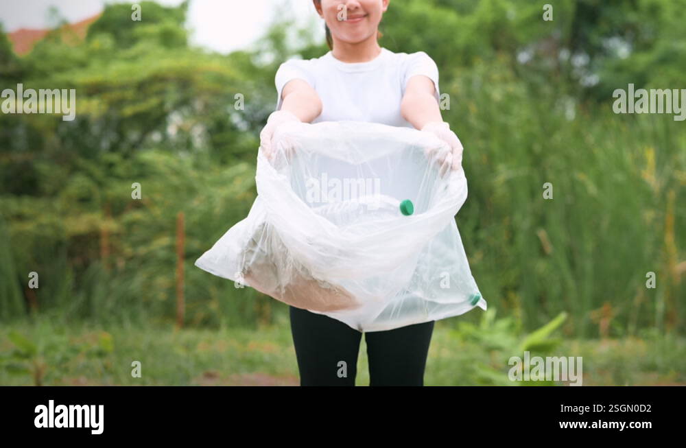 woman is collecting recycling junk on ground , ecological sustainable ...