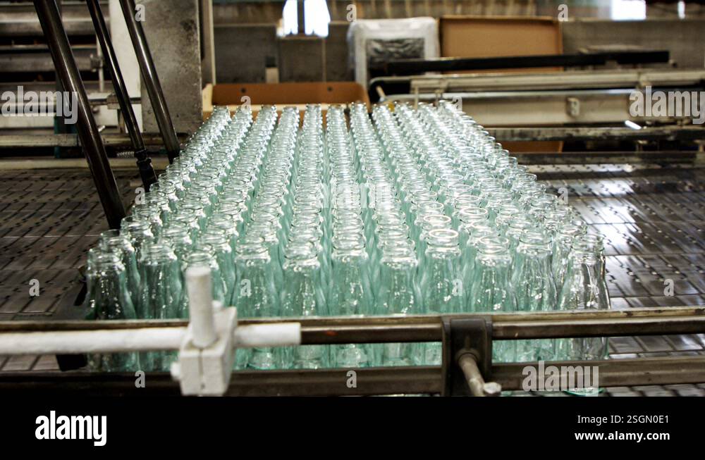 Glass bottles production. Glass bottles on a conveyor belt in an ...