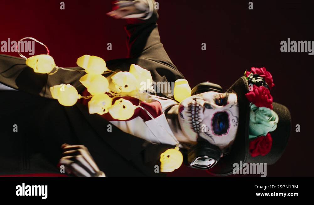 Vertical video: Horror model with costume of death dancing in studio ...