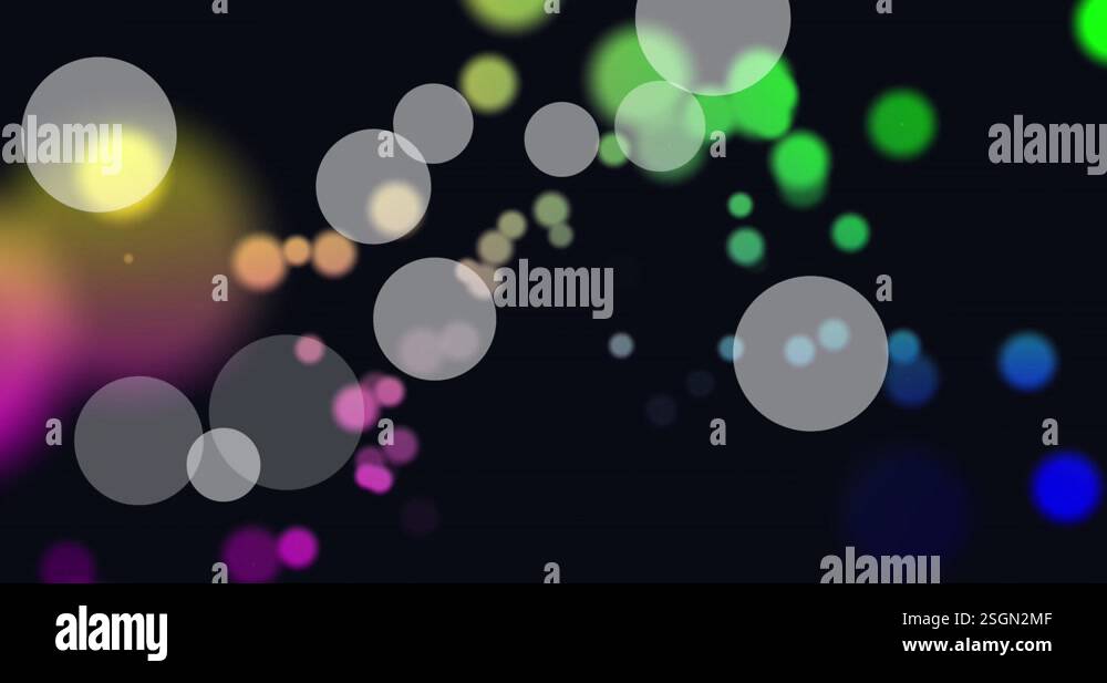 Animation of white and colorful spots of light floating against black ...
