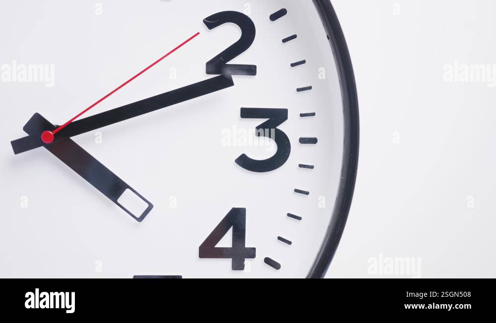 part of a round white wall clock with a red second hand on a white ...