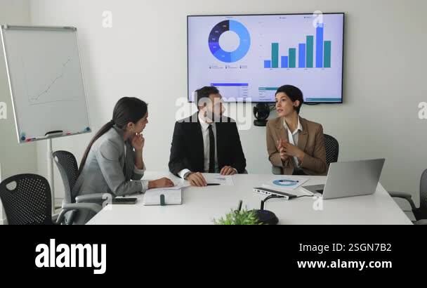 Team engaged in decision-making, communication during formal business ...