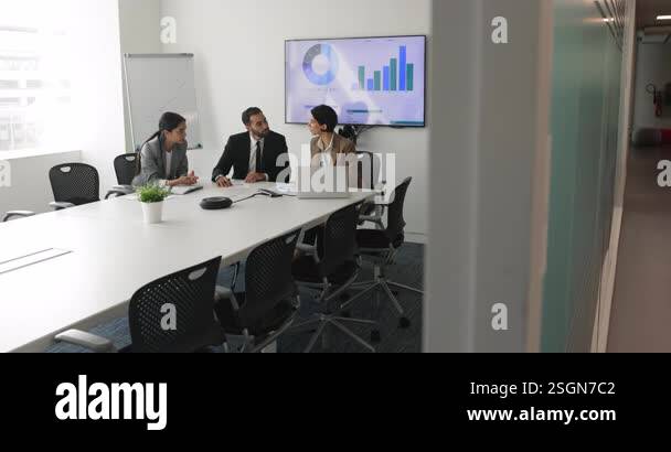 Professional business meeting in modern boardroom, wide view. Three ...