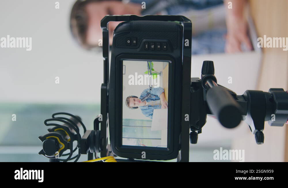 Vertical Video Of Display On Back Of Camera Showing Male Vlogger Live ...