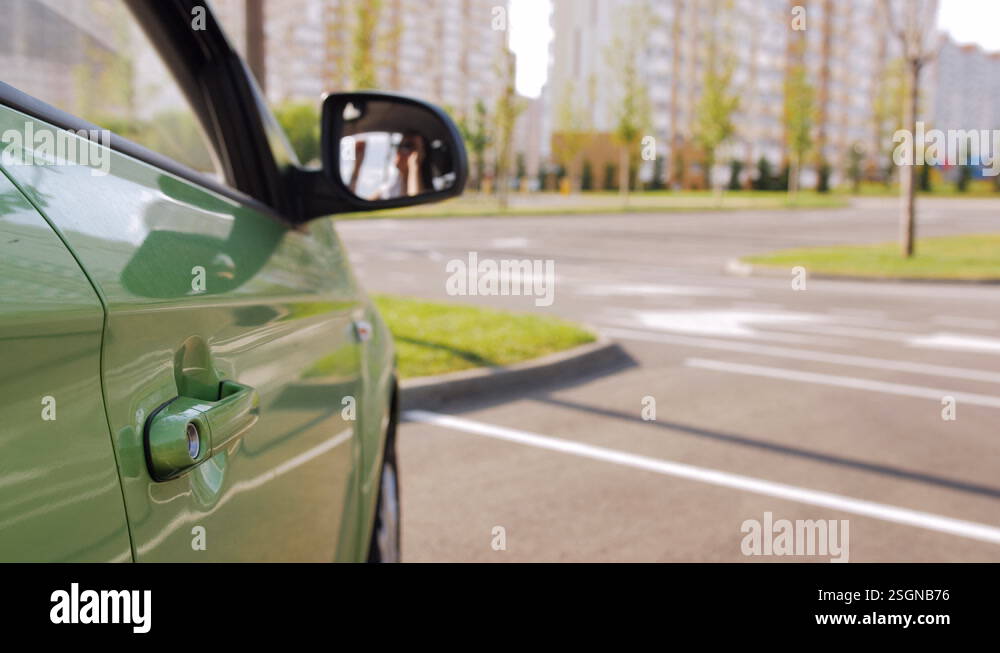 A woman throws garbage in a plastic bag out of a car window. The ...