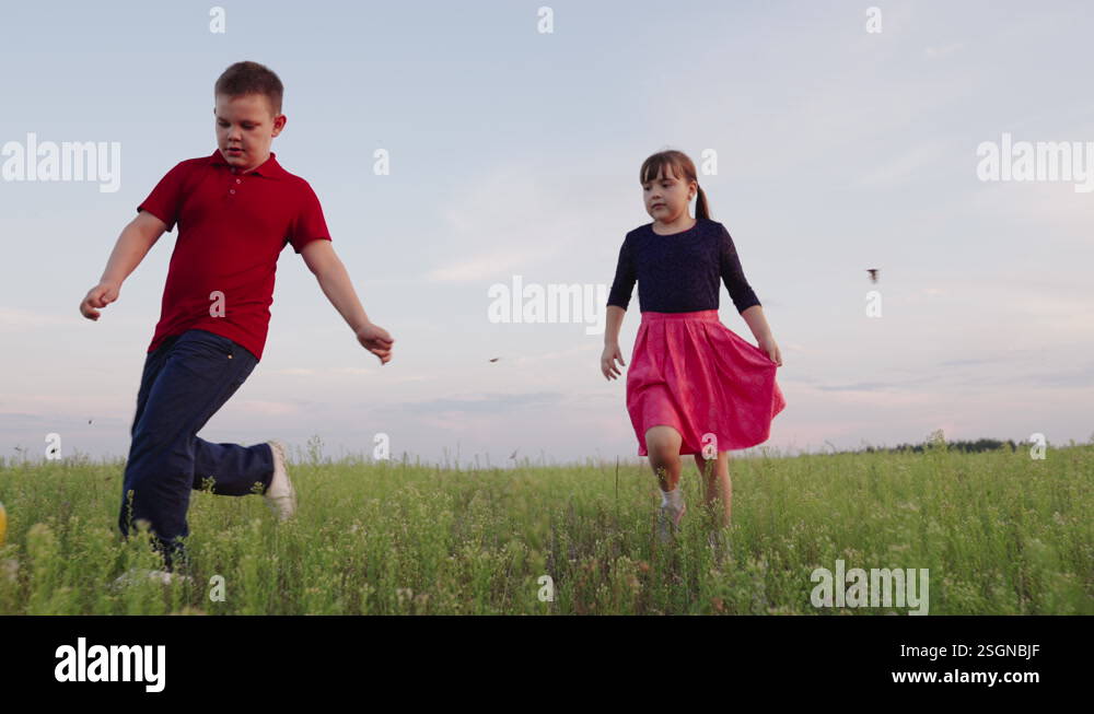 children run field kicking ball with their feet lawn. chidhood dream ...