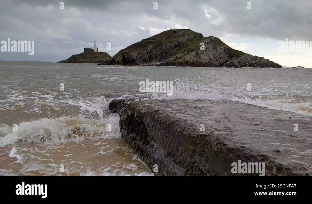 Slow Motion Waves Rolling In with Island Lighthouse Background on Windy ...