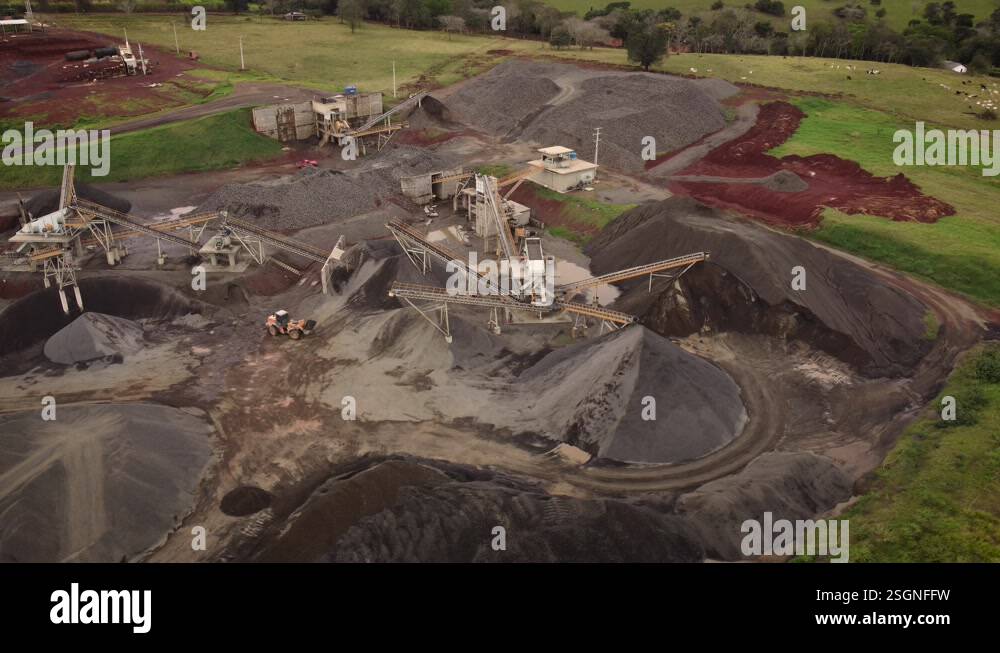 Excavator at work in open stone quarry, Brazil near Iguazu River ...