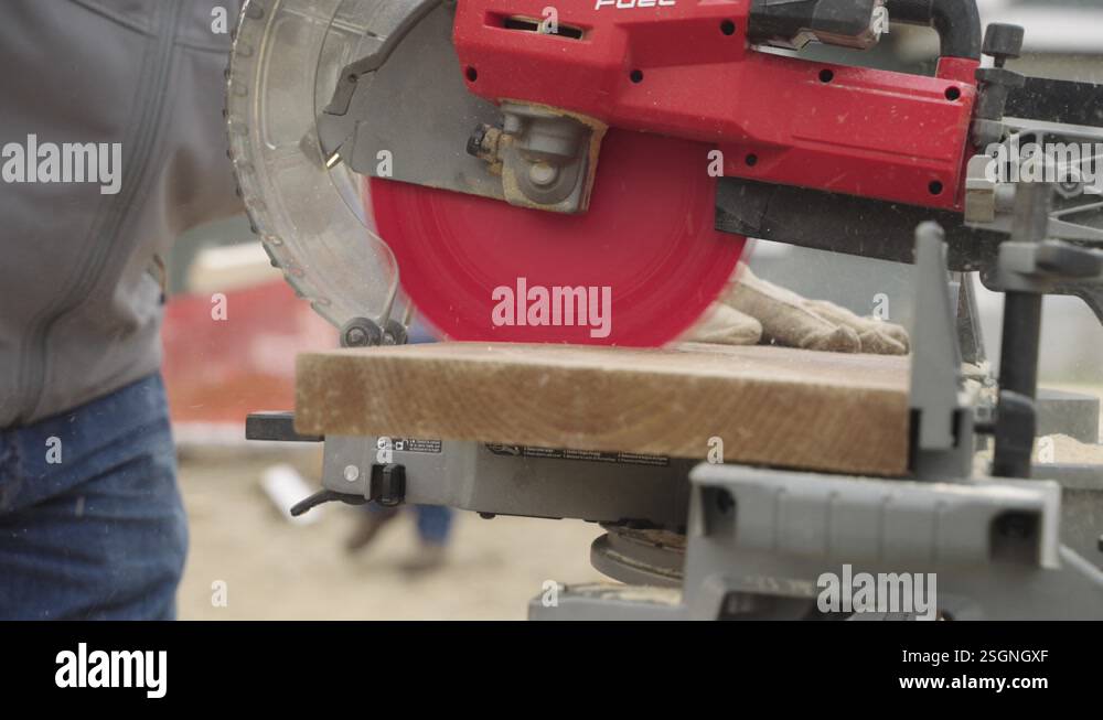 Slow motion, circular saw suddenly stopping after safety mechanism ...