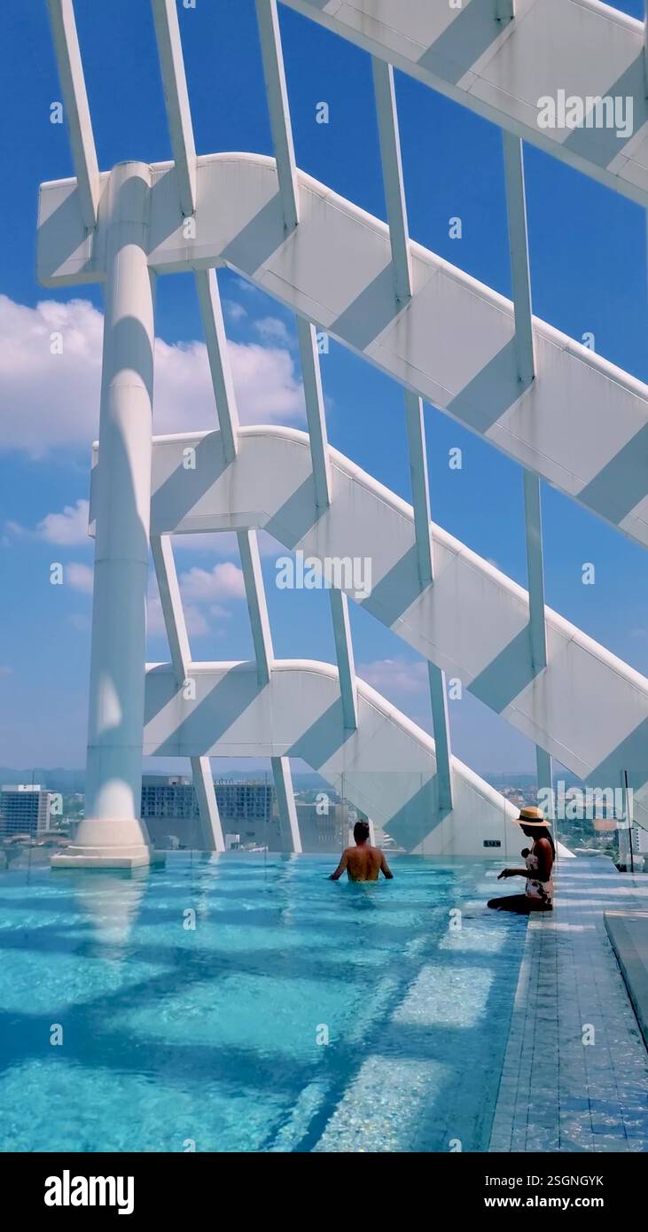 couple men and women relaxing at a rooftop pool of a luxury hotel Stock ...