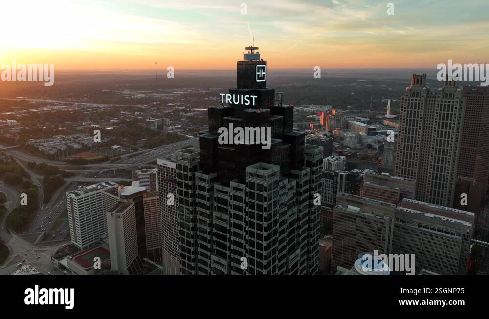 Truist Tower Plaza. Aerial orbit of logo sign at dawn. Downtown Atlanta ...