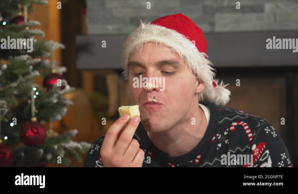 PORTRAIT Man eats delicious Christmas dessert and his face is smeared ...