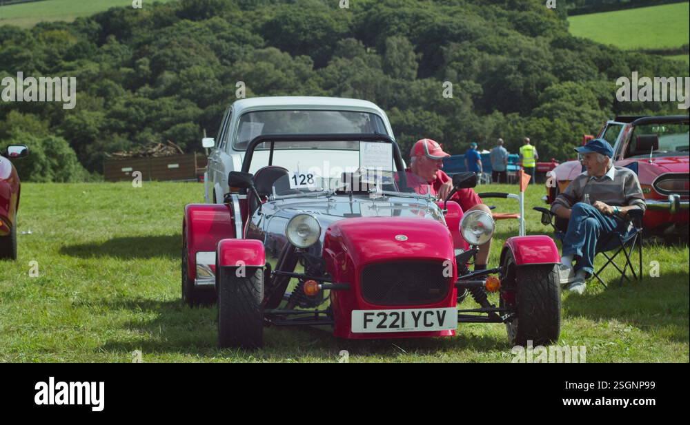 Two Old Men Sitting And Talking Next To A Red Caterham Seven Sports Car ...